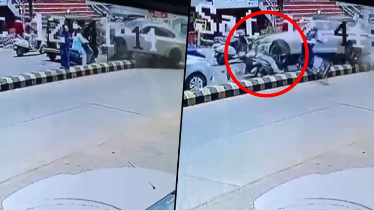 BMW car jumps divider, rams the scooty and injures woman; watch ...