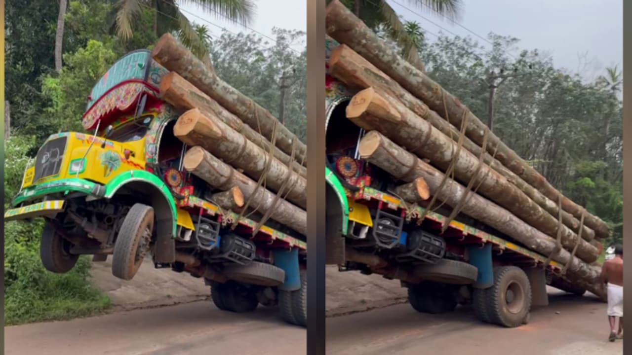 front end of the lorry that carried tree woods lifted up on the hilly ...