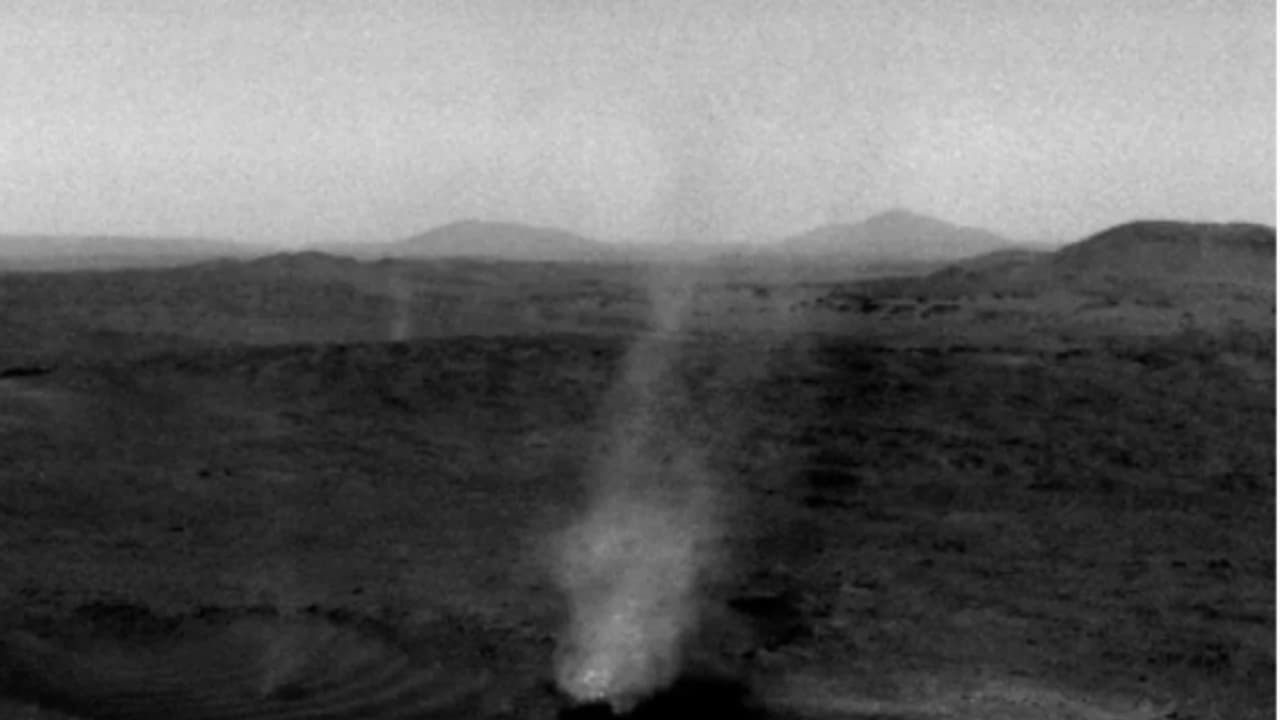 Watch video of a large dust devil consumed a smaller nearby dust devil ...