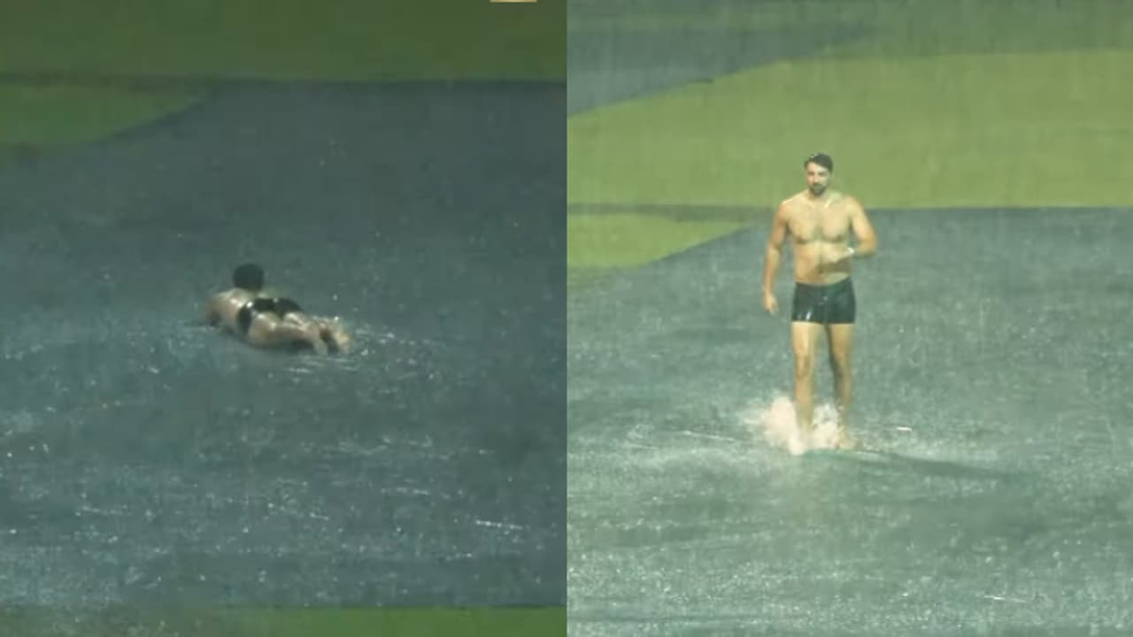 RCB's Tim Tim David swimming on the pitch cover: ചിന്നസ്വാമിയി ...